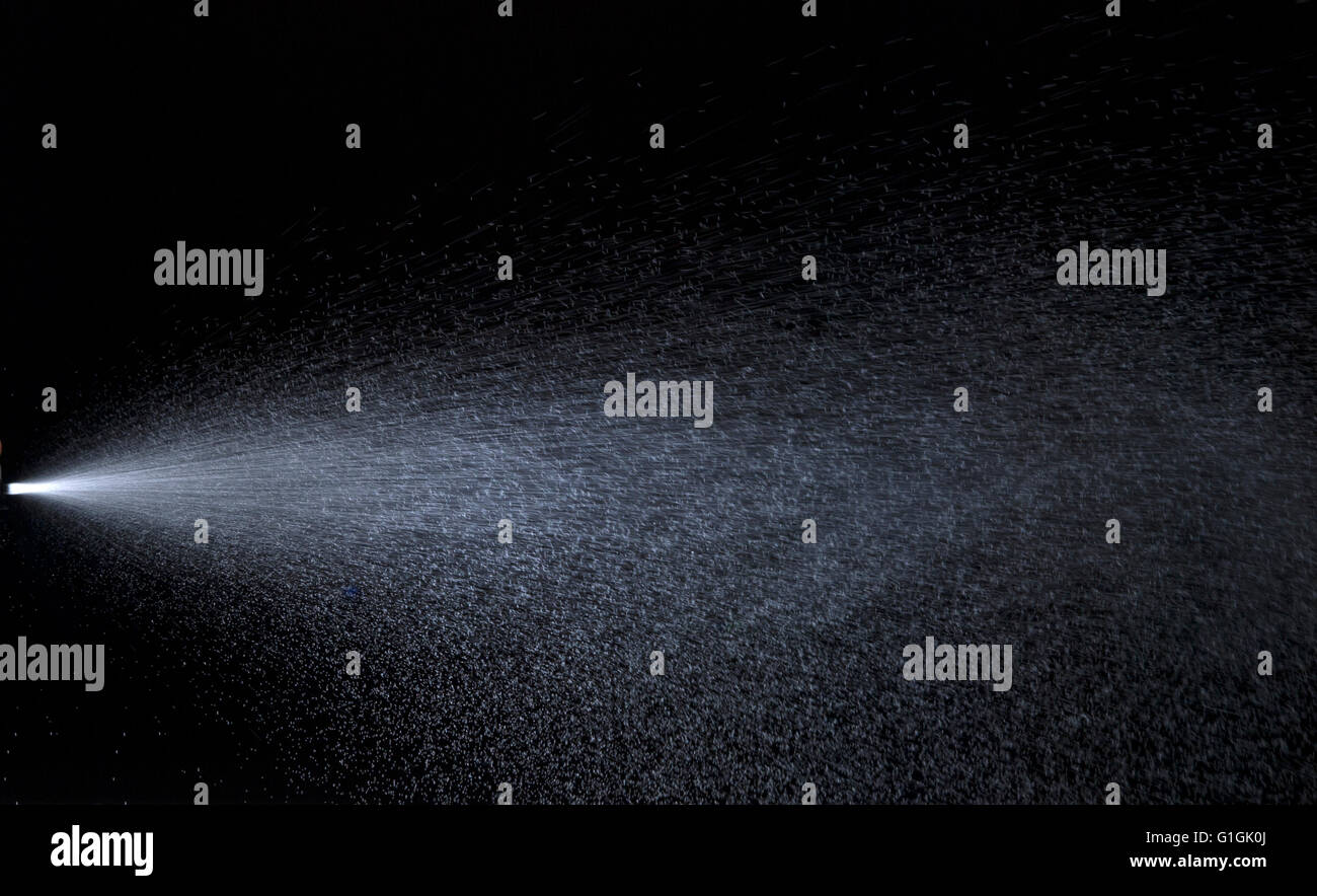 Water jet spraying on black background Stock Photo - Alamy