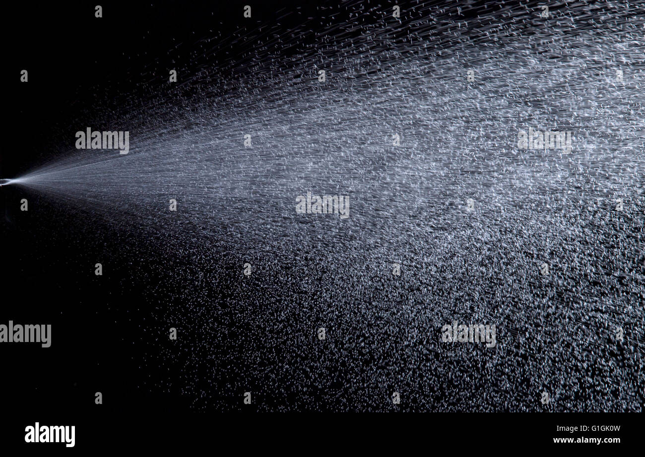 Water jet spraying on black background Stock Photo - Alamy