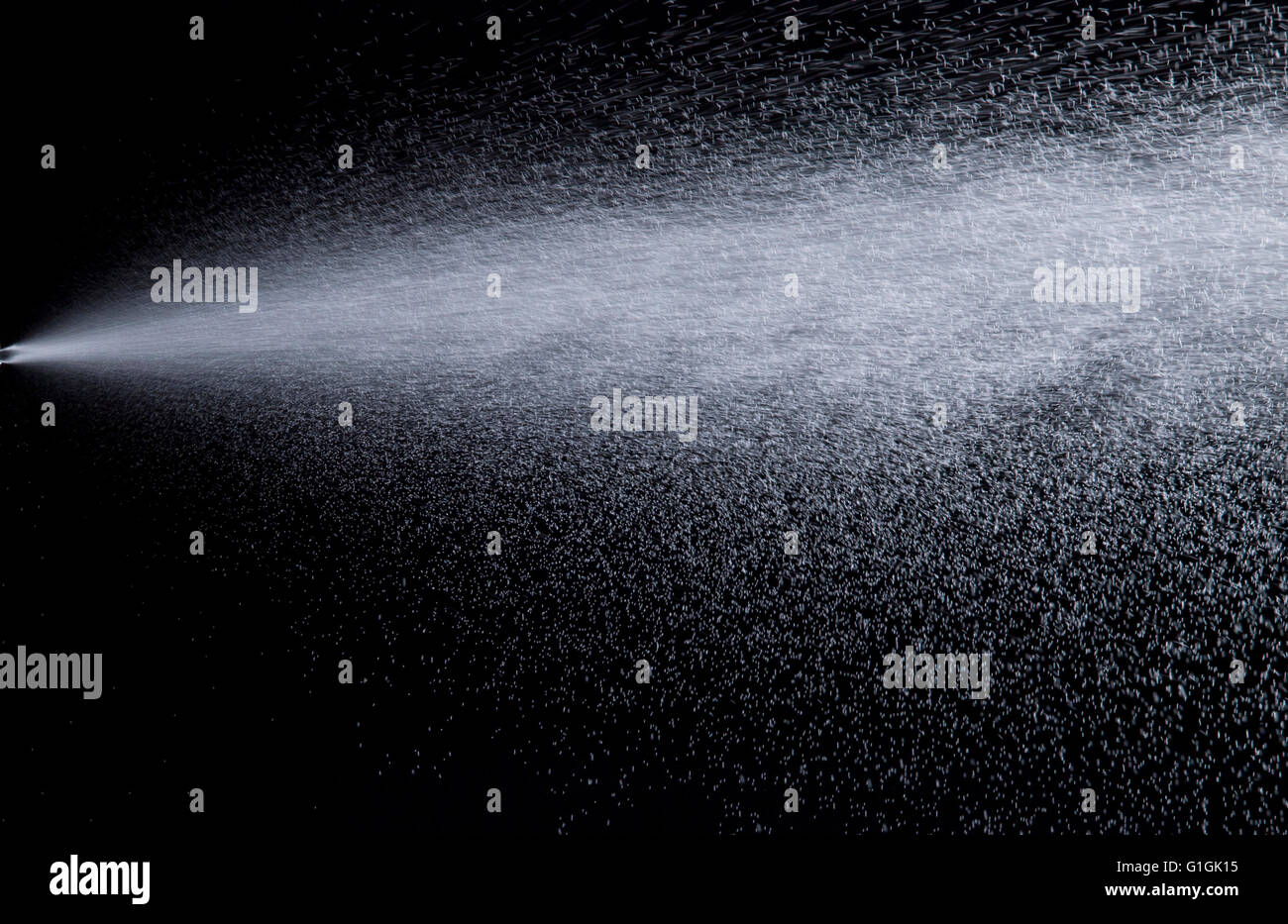 Water jet spraying on black background Stock Photo - Alamy