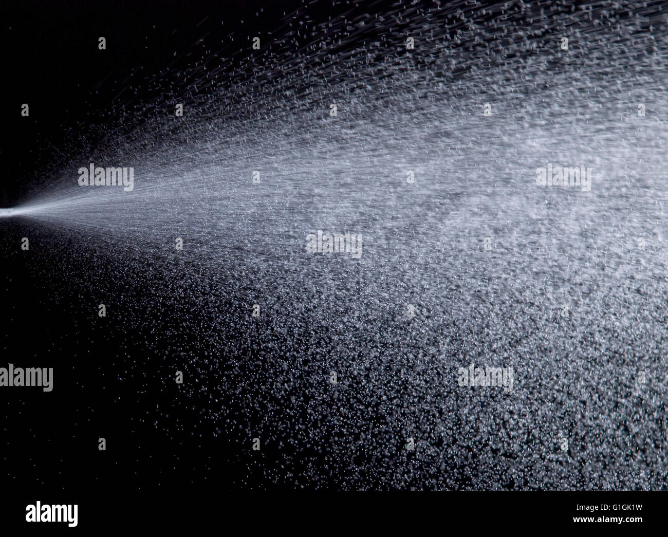 Water jet spraying on black background Stock Photo - Alamy