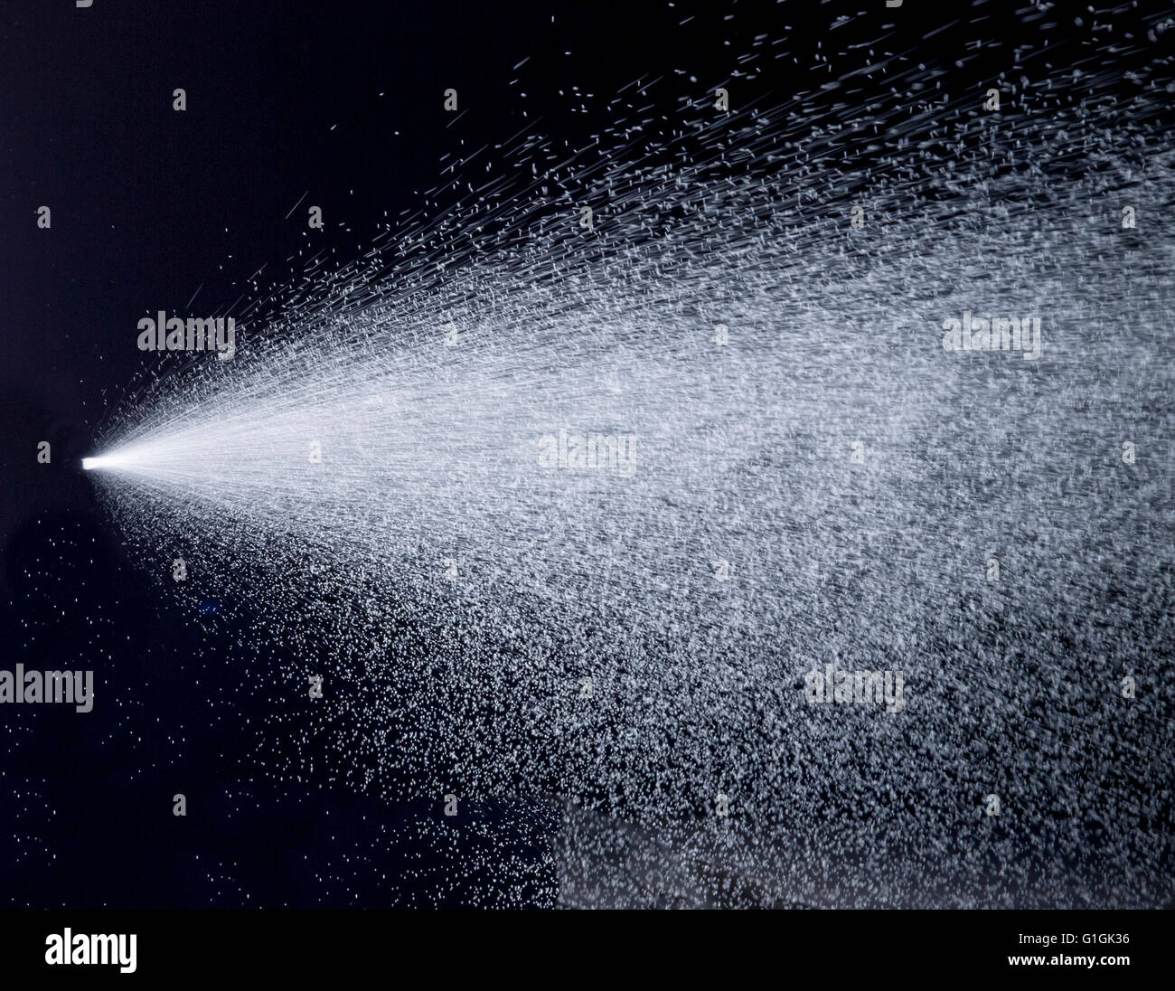 Water jet spraying on black background Stock Photo - Alamy