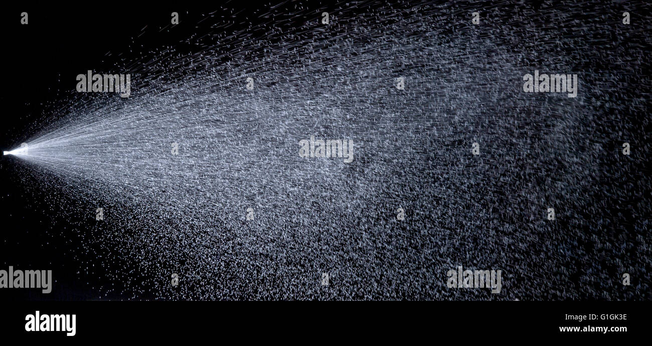 Water jet spraying on black background Stock Photo - Alamy