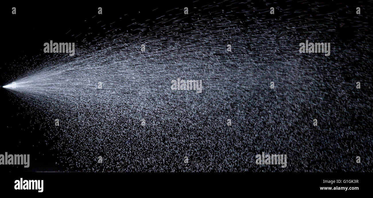 Water jet spraying on black background Stock Photo - Alamy