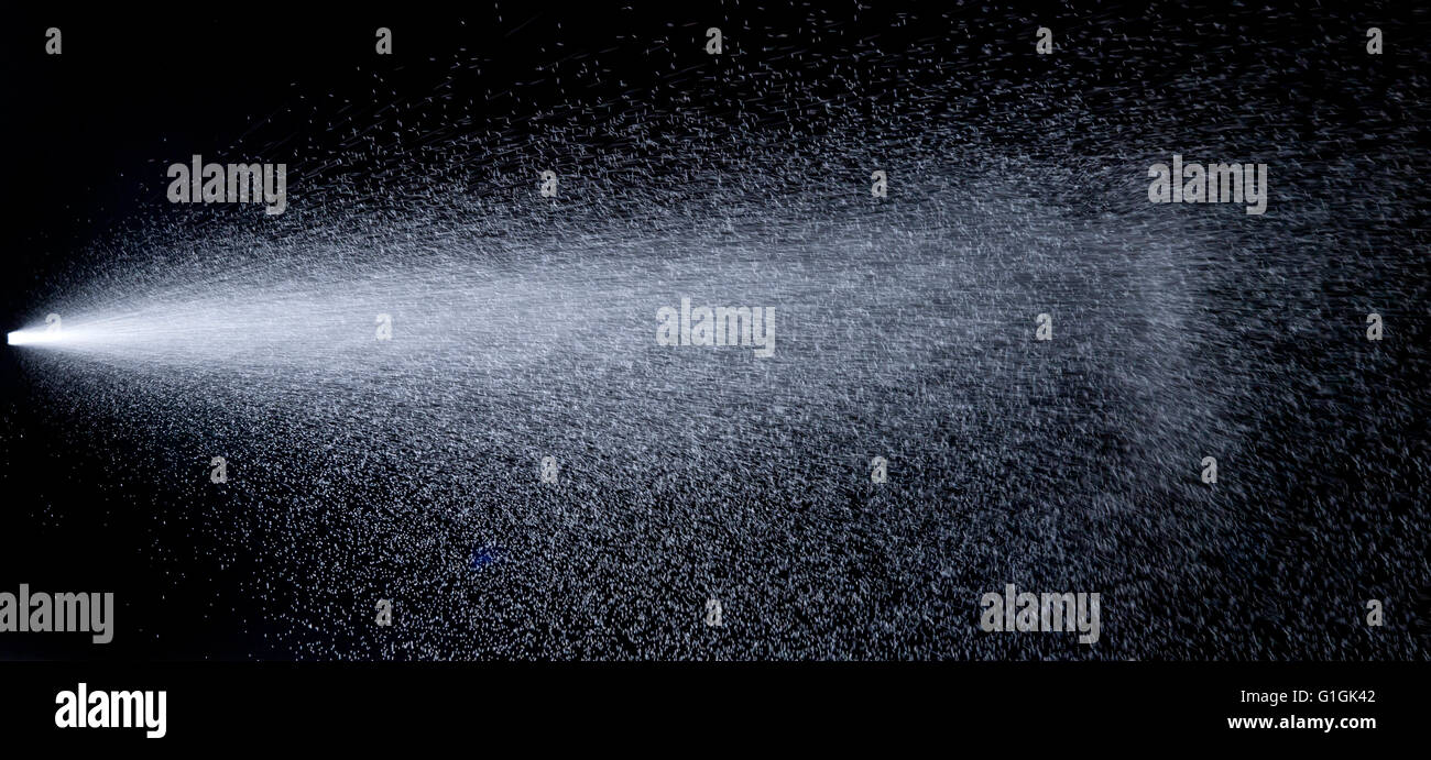 Water jet spraying on black background Stock Photo - Alamy