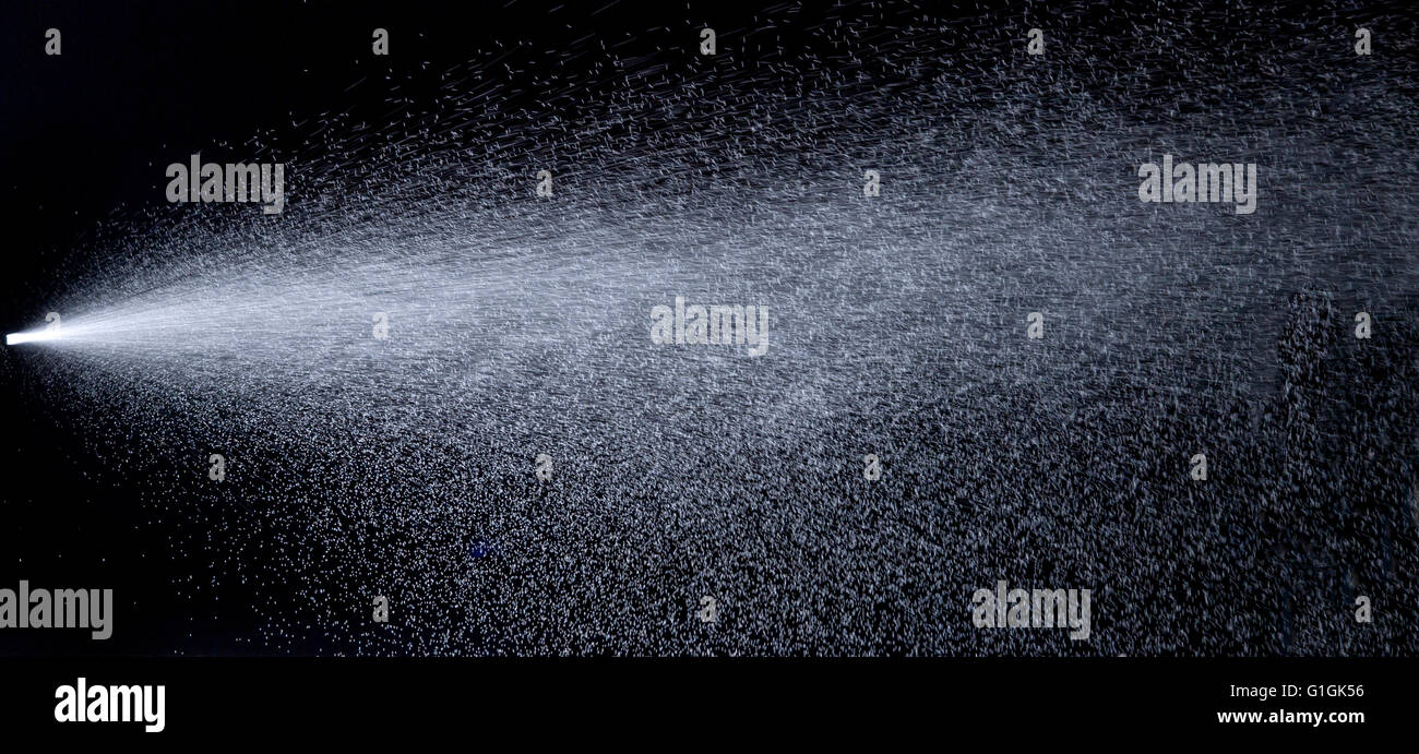 Water jet spraying on black background Stock Photo - Alamy