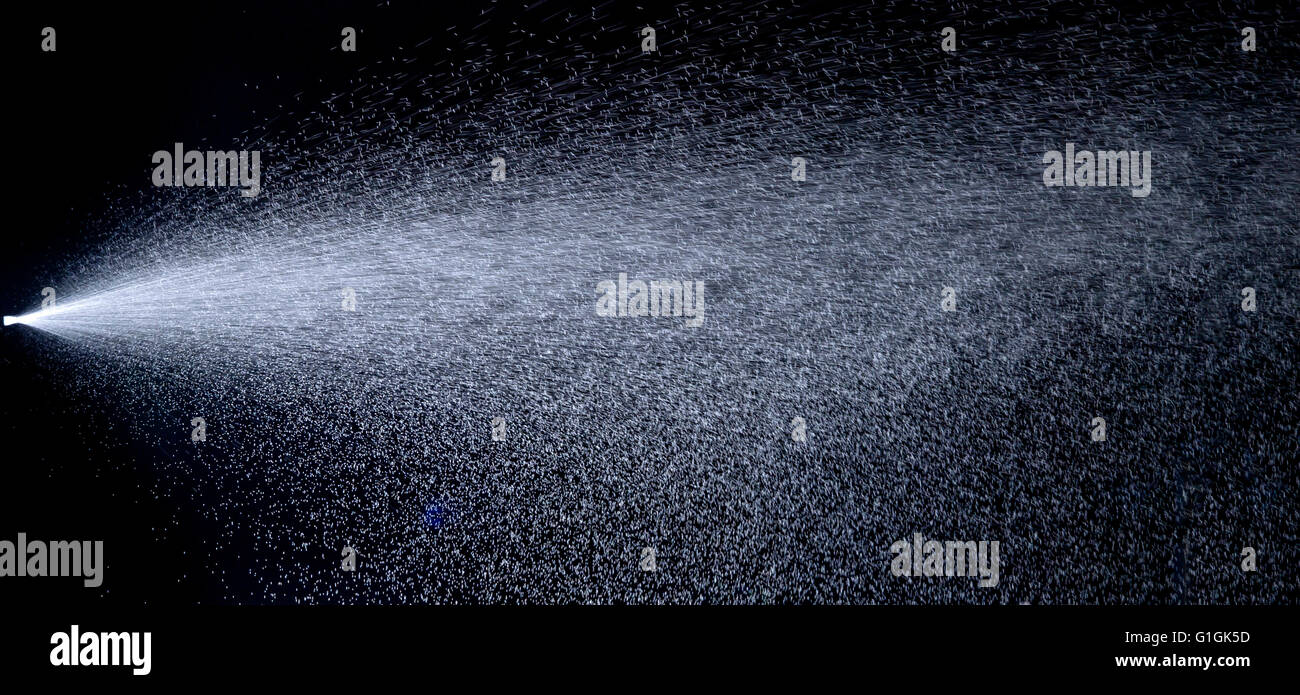 Water jet spraying on black background Stock Photo - Alamy