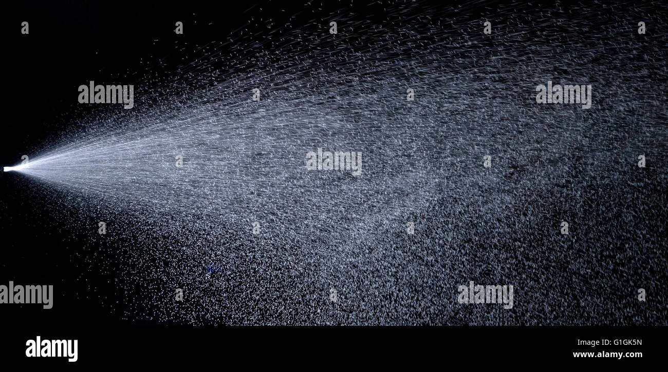 Water jet spraying on black background Stock Photo - Alamy