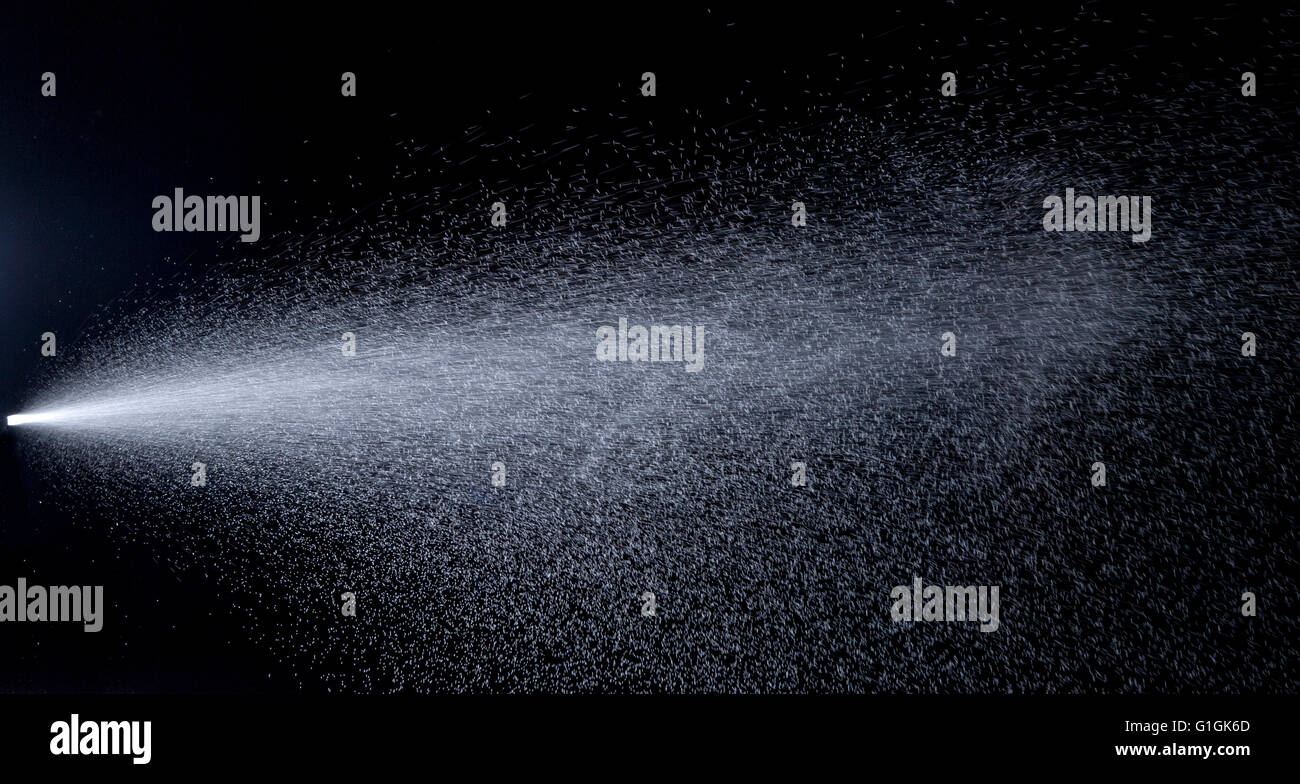 Water jet spraying on black background Stock Photo - Alamy