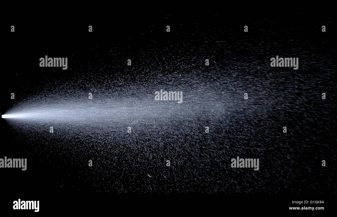 Water jet spraying on black background Stock Photo - Alamy