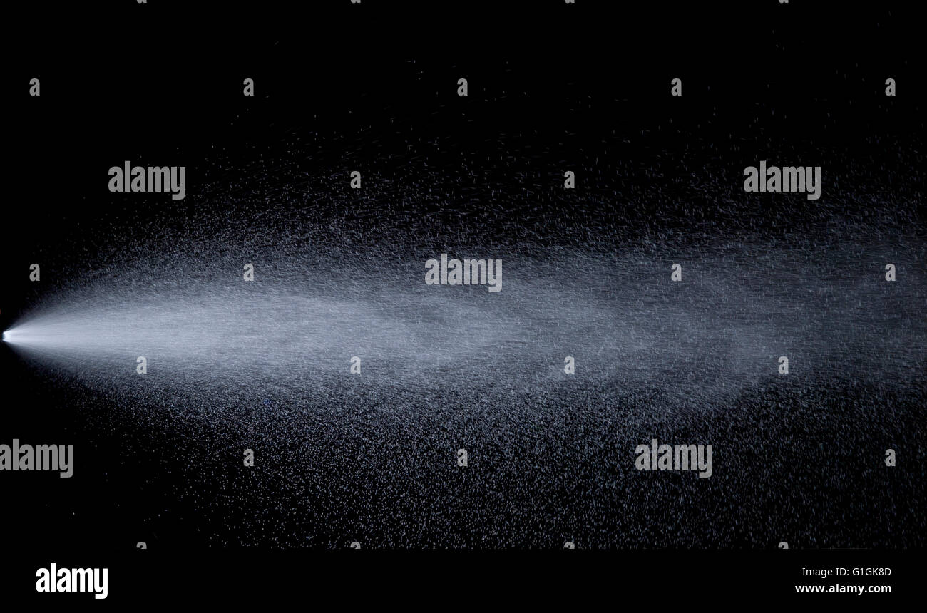 Water jet spraying on black background Stock Photo - Alamy