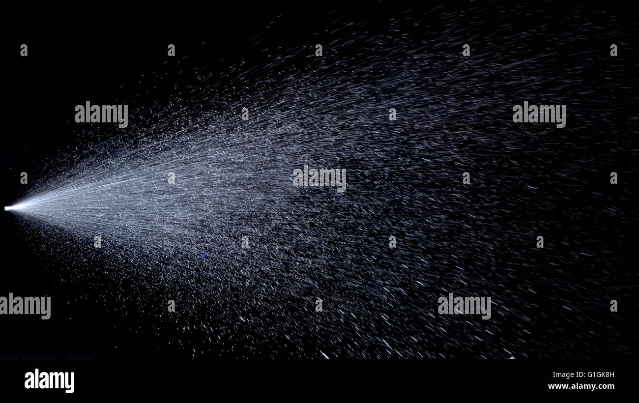Water jet spraying on black background Stock Photo - Alamy