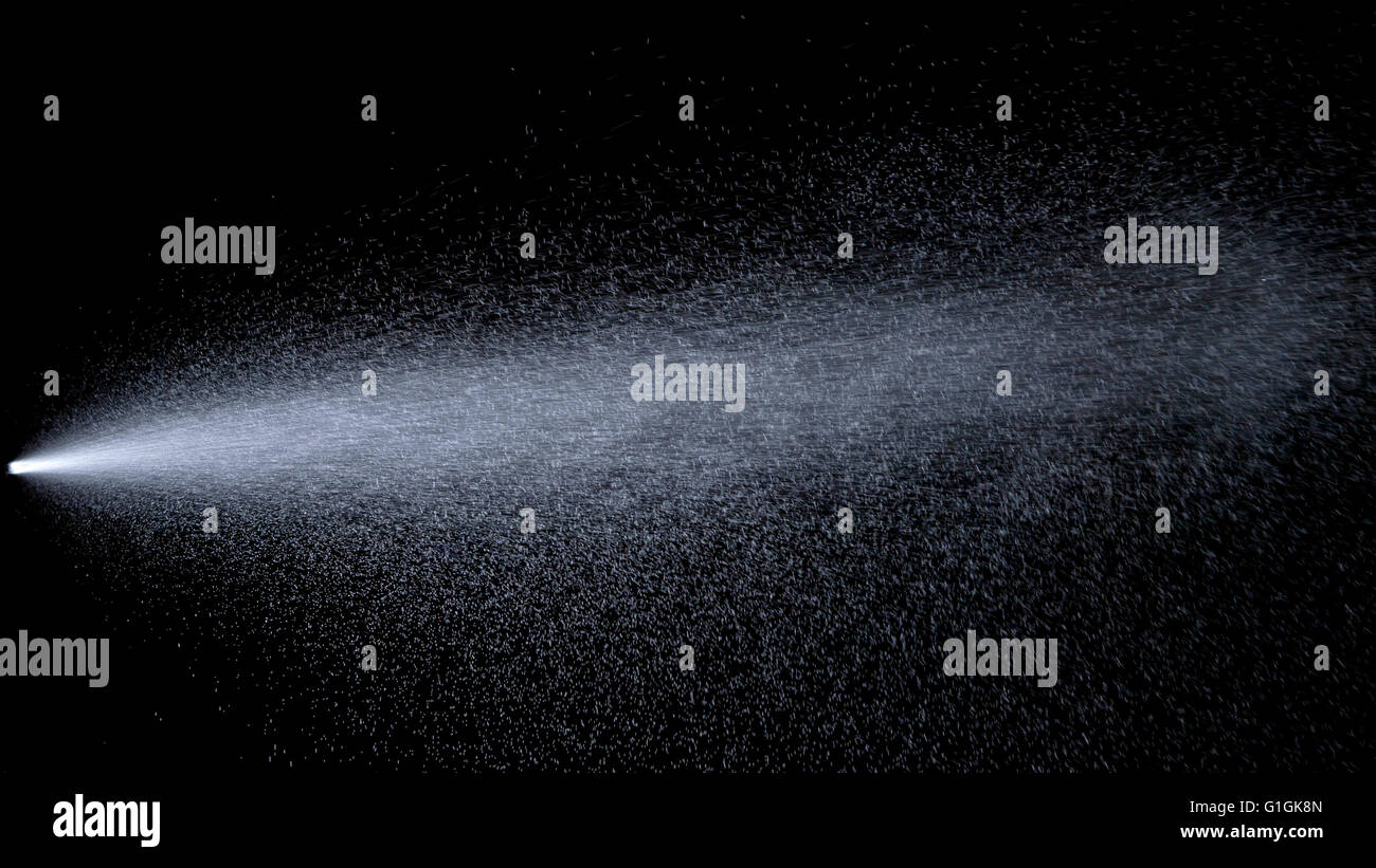 Water jet spraying on black background Stock Photo - Alamy