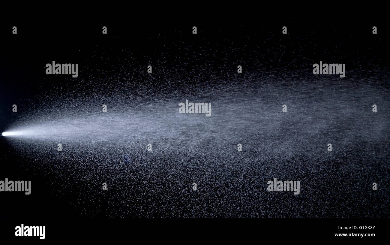 Water jet spraying on black background Stock Photo - Alamy