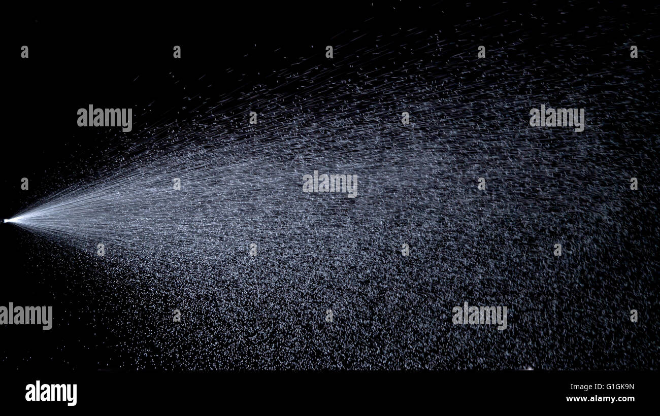 Water jet spraying on black background Stock Photo - Alamy