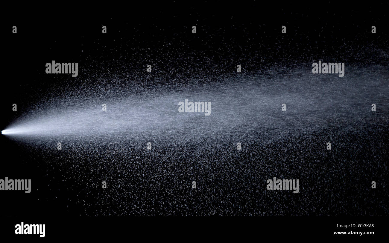 Water jet spraying on black background Stock Photo - Alamy