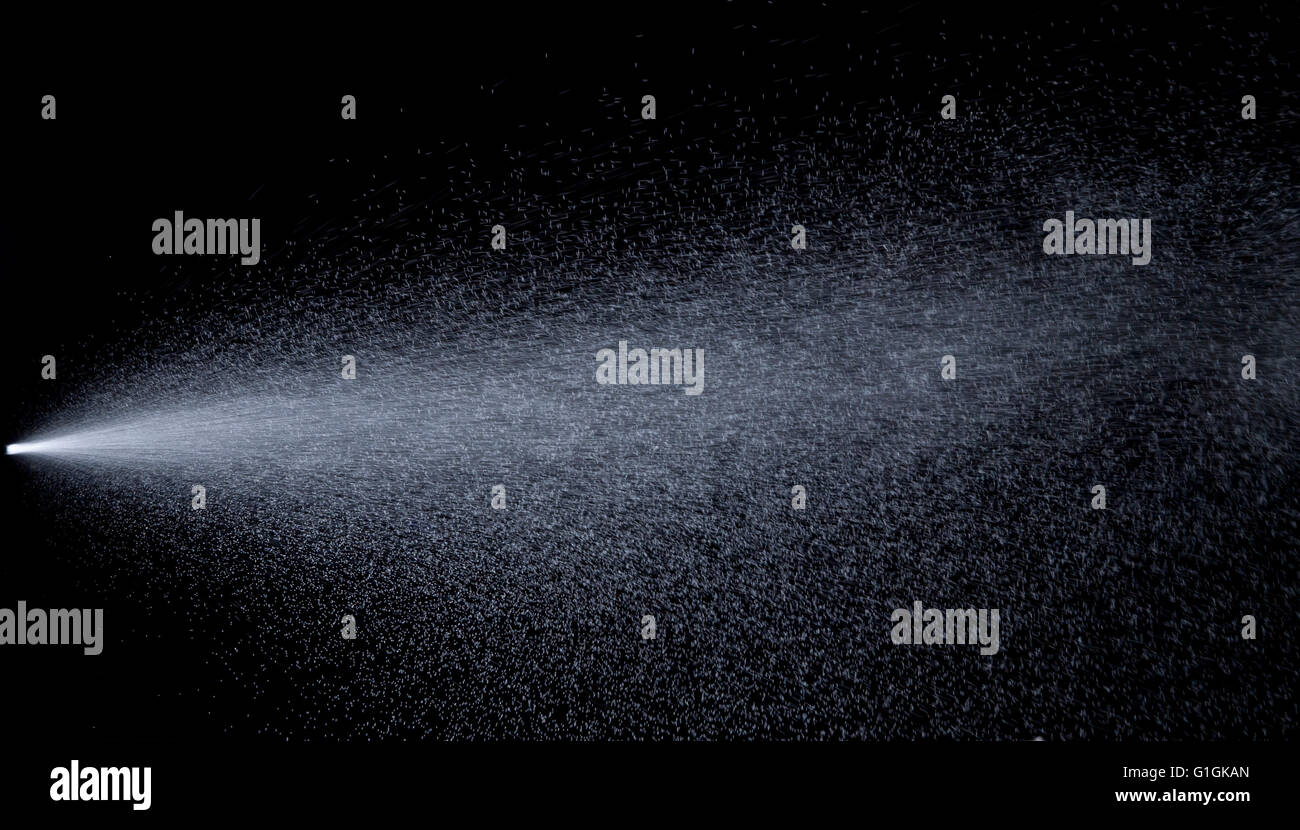 Water jet spraying on black background Stock Photo - Alamy