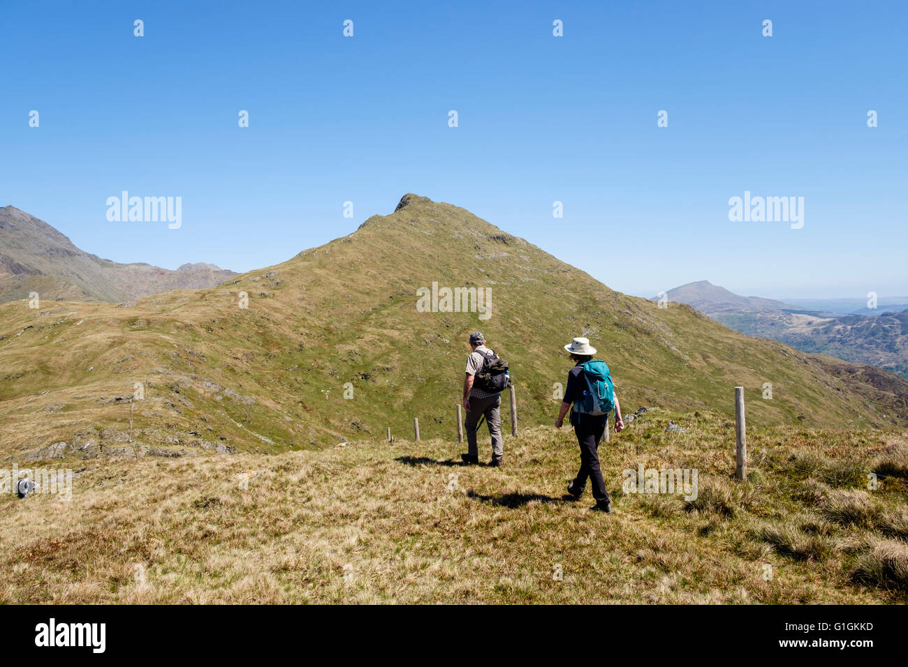 Two hikers hiking on Craig Wen ridge to Yr Aran in mountains of ...