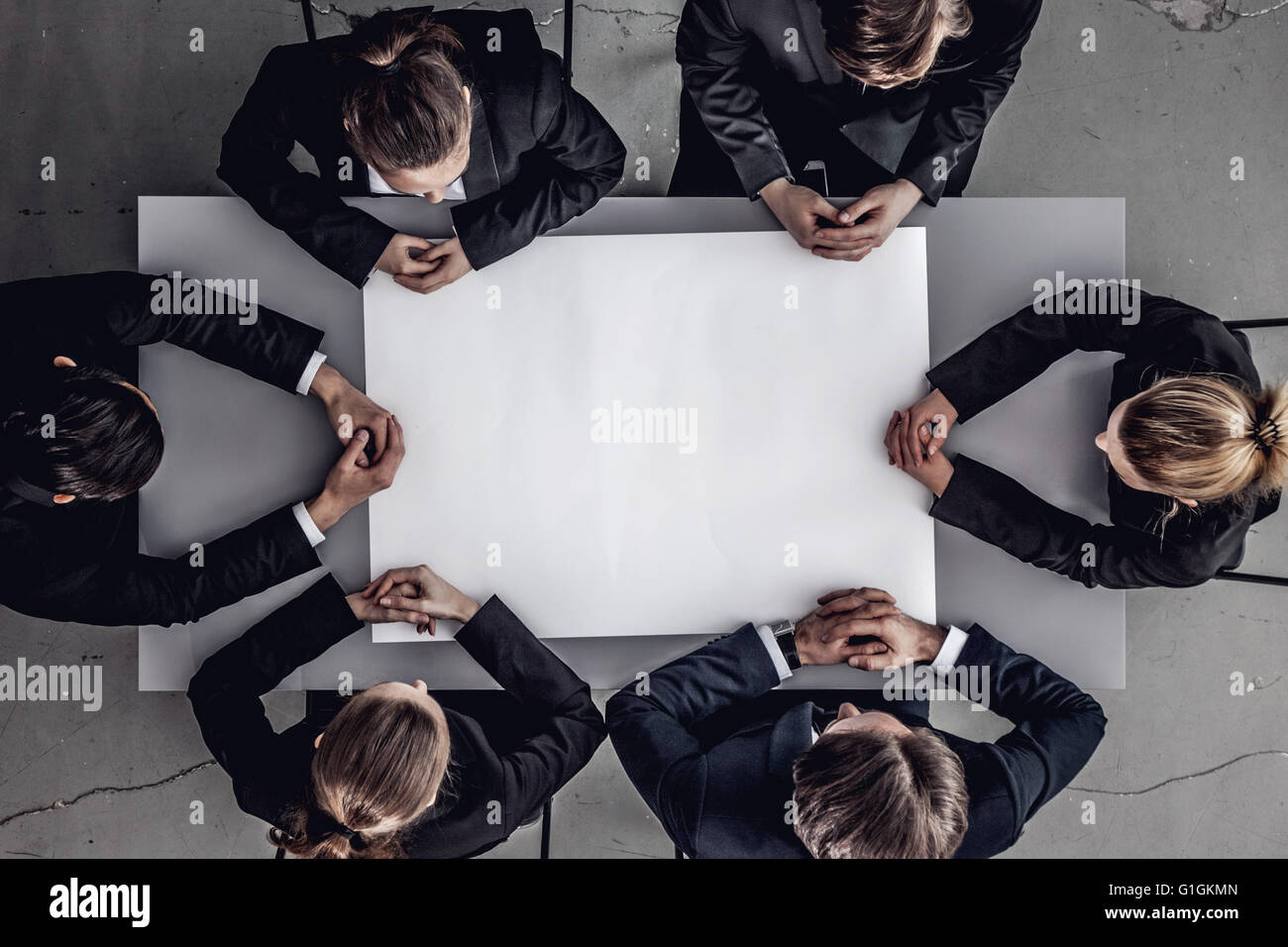 Business people at meeting around the table with blank paper Stock ...