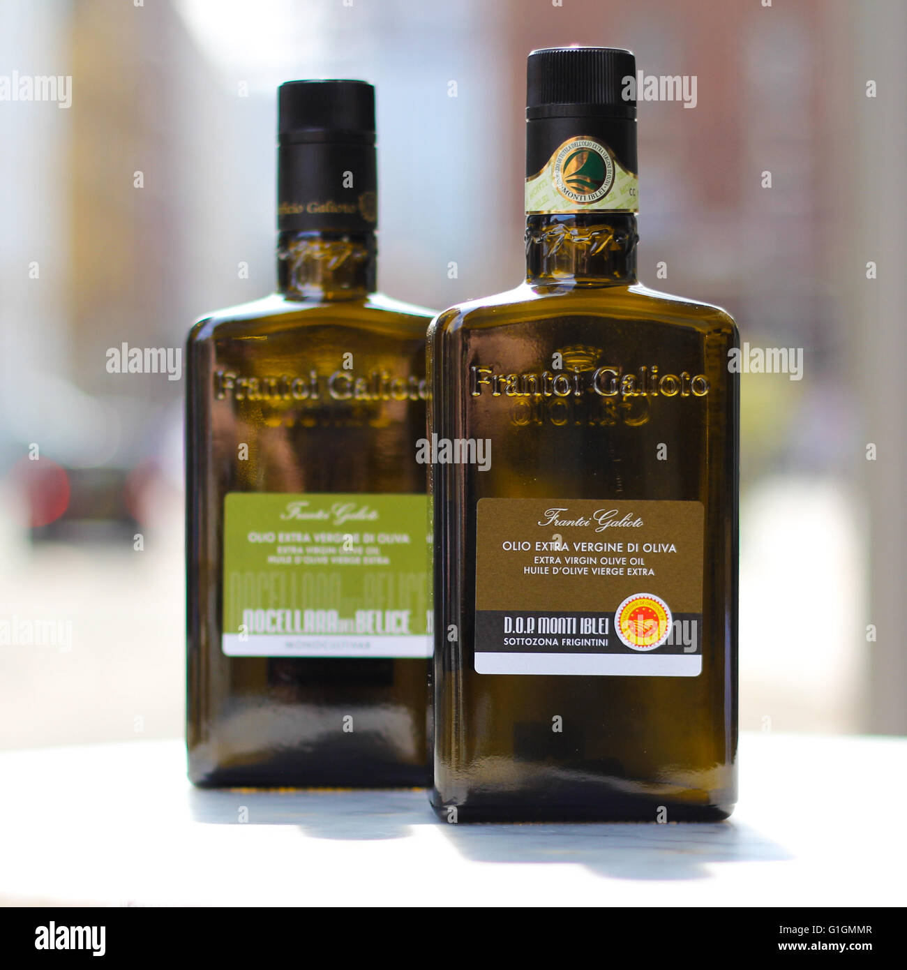 Two bottles of Italian olive oil sat on a marble table top Stock Photo ...