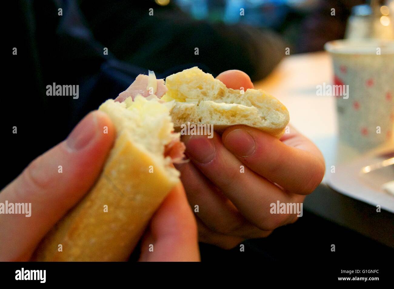 Breaking a sandwich in half Stock Photo - Alamy