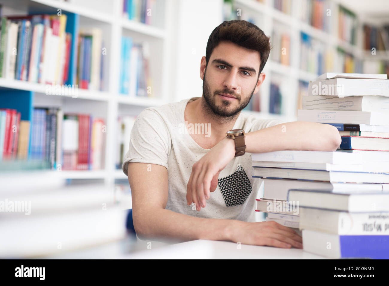 Student reading book in school library. Study lessons for exam. Hard ...