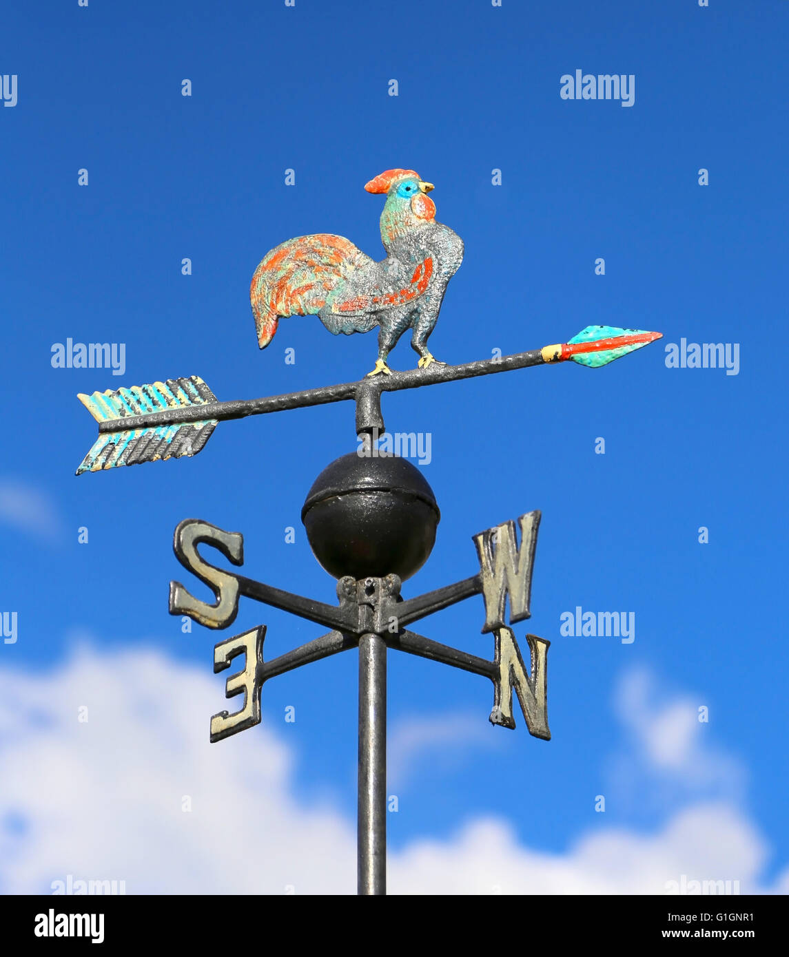 ancient weathervane with cock above an arrow and the four cardinal ...
