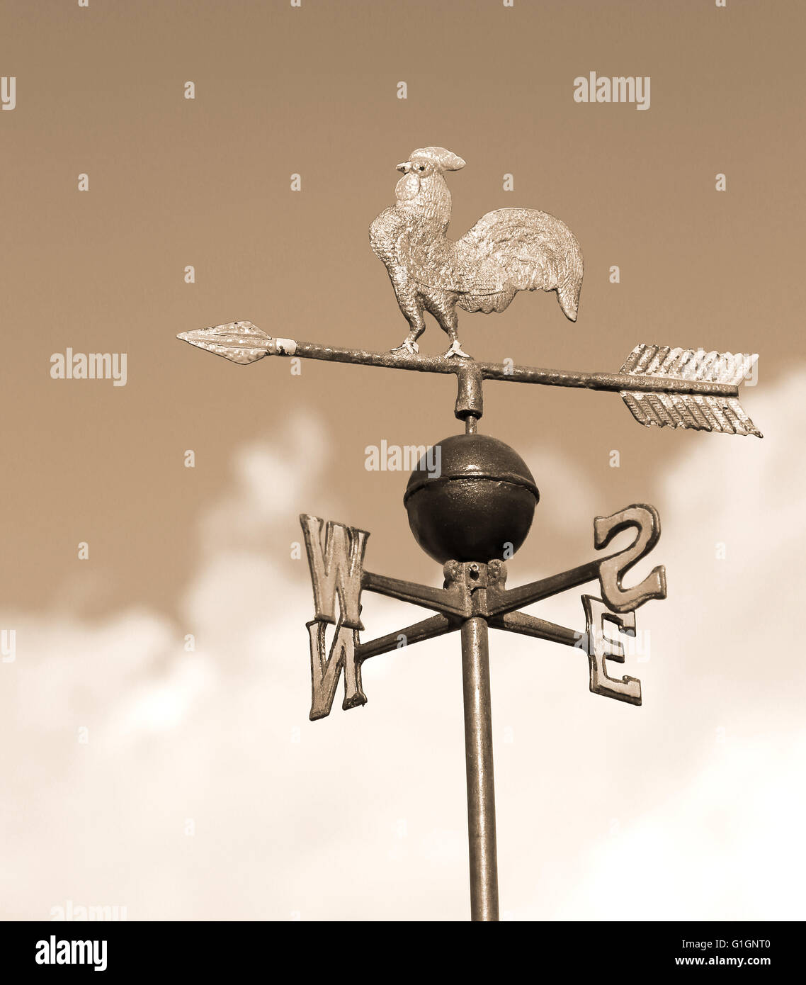 ancient weathervane with cock above an arrow and the four cardinal ...