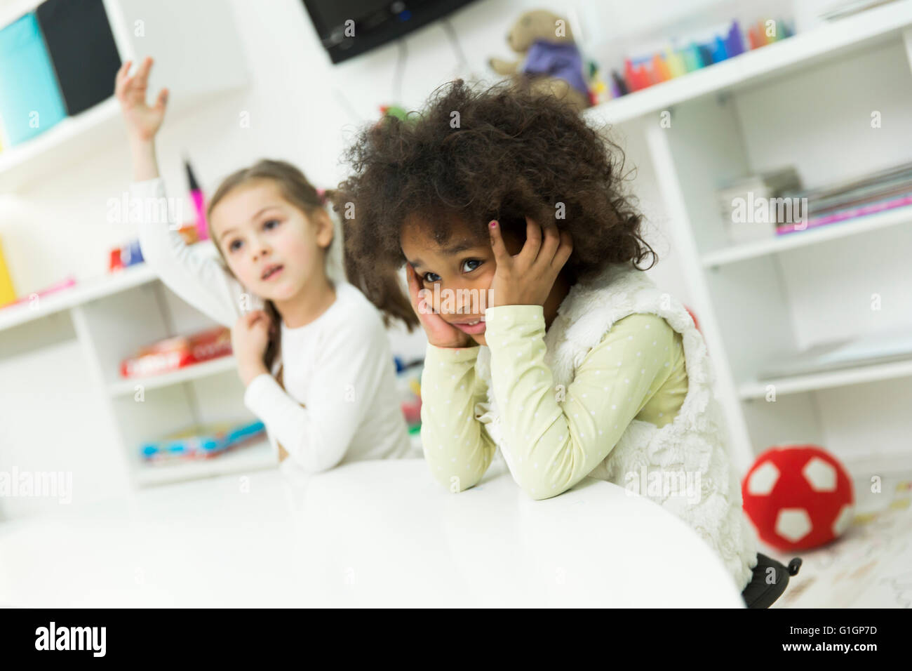 Kids sitting at the table in the kindergarten Stock Photo - Alamy