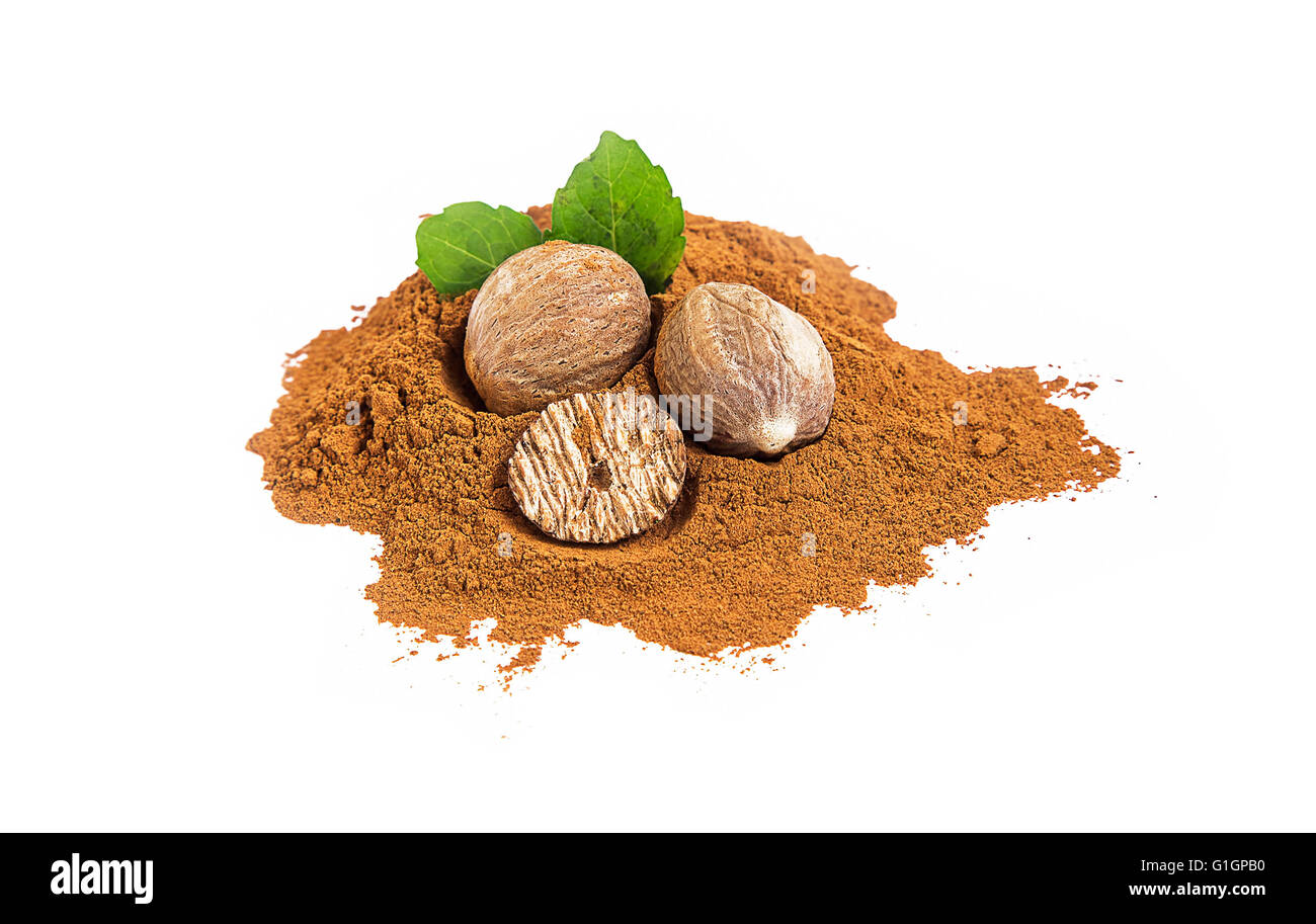 Ground nutmeg and whole nutmeg with green leaves isolated Stock Photo ...