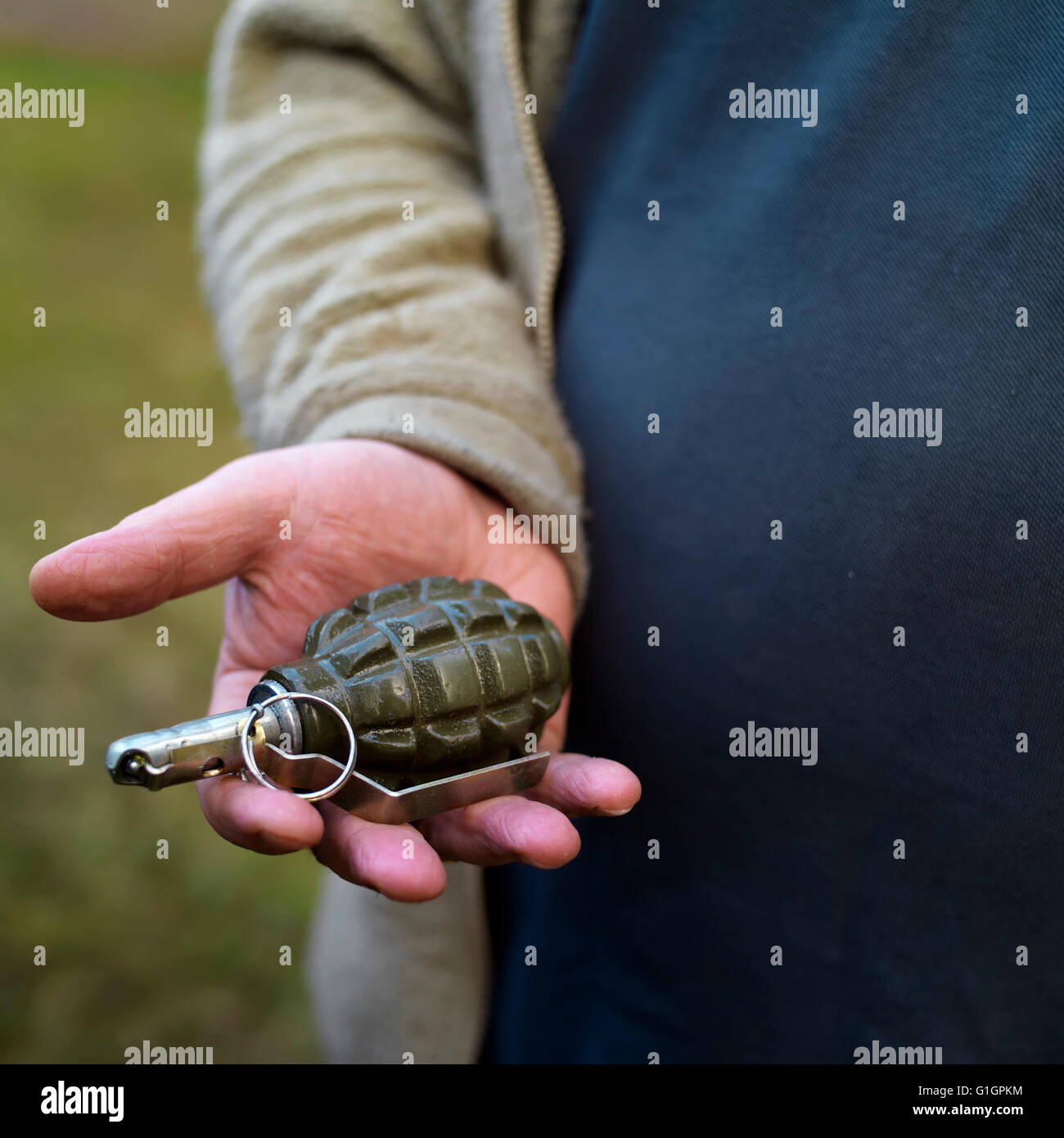 Male hand holding grenade Stock Photo - Alamy