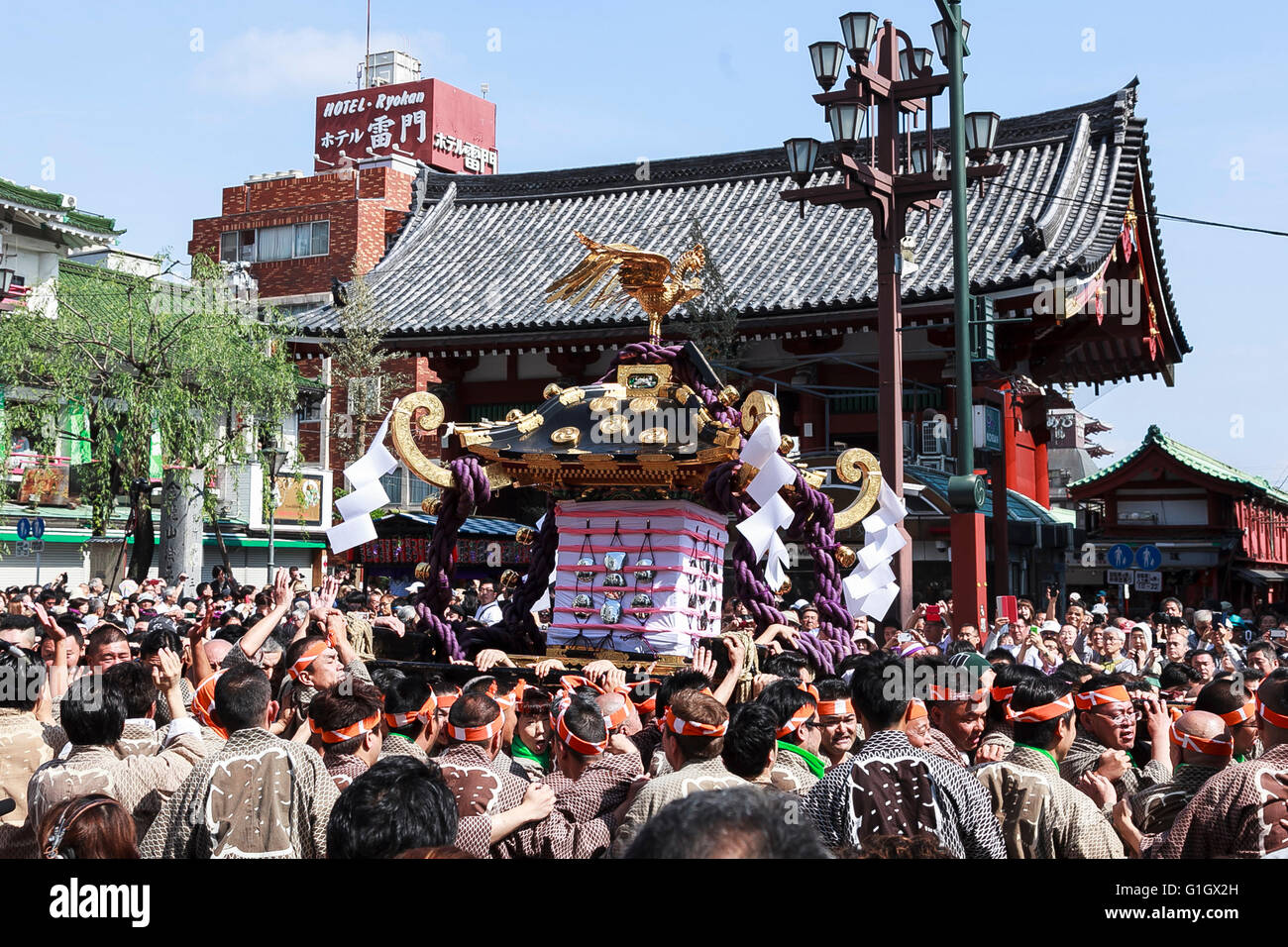 Sanja Festival participants carry a mikoshi (portable shrine) in front ...
