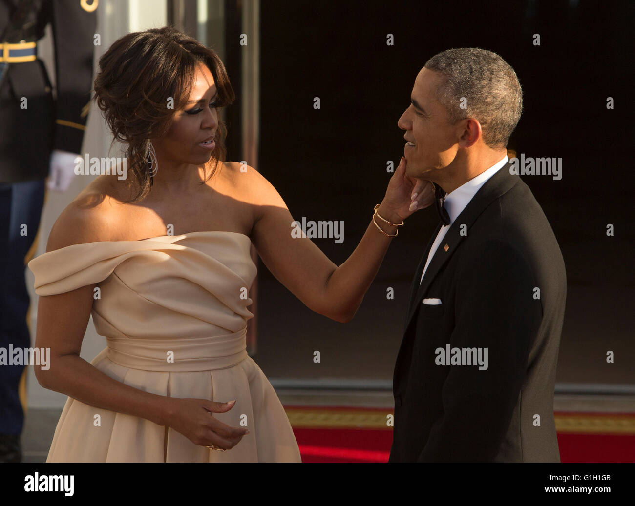 First Lady Michelle Obama touches the chin of United States President ...