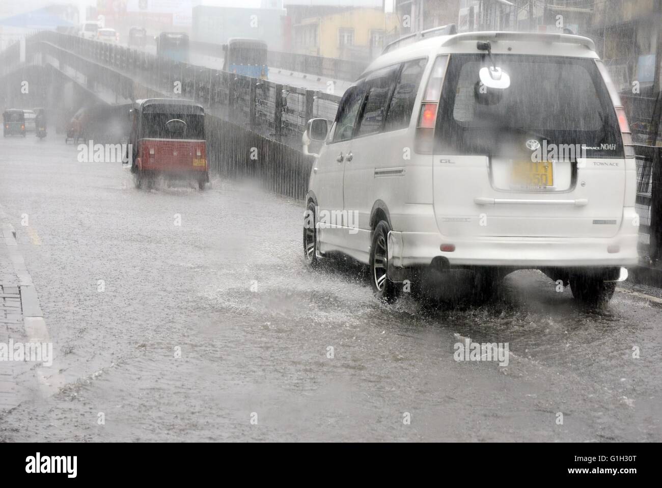 Colombo, Sri Lanka. 14th May, 2016. Vehicles wade through a flooded ...