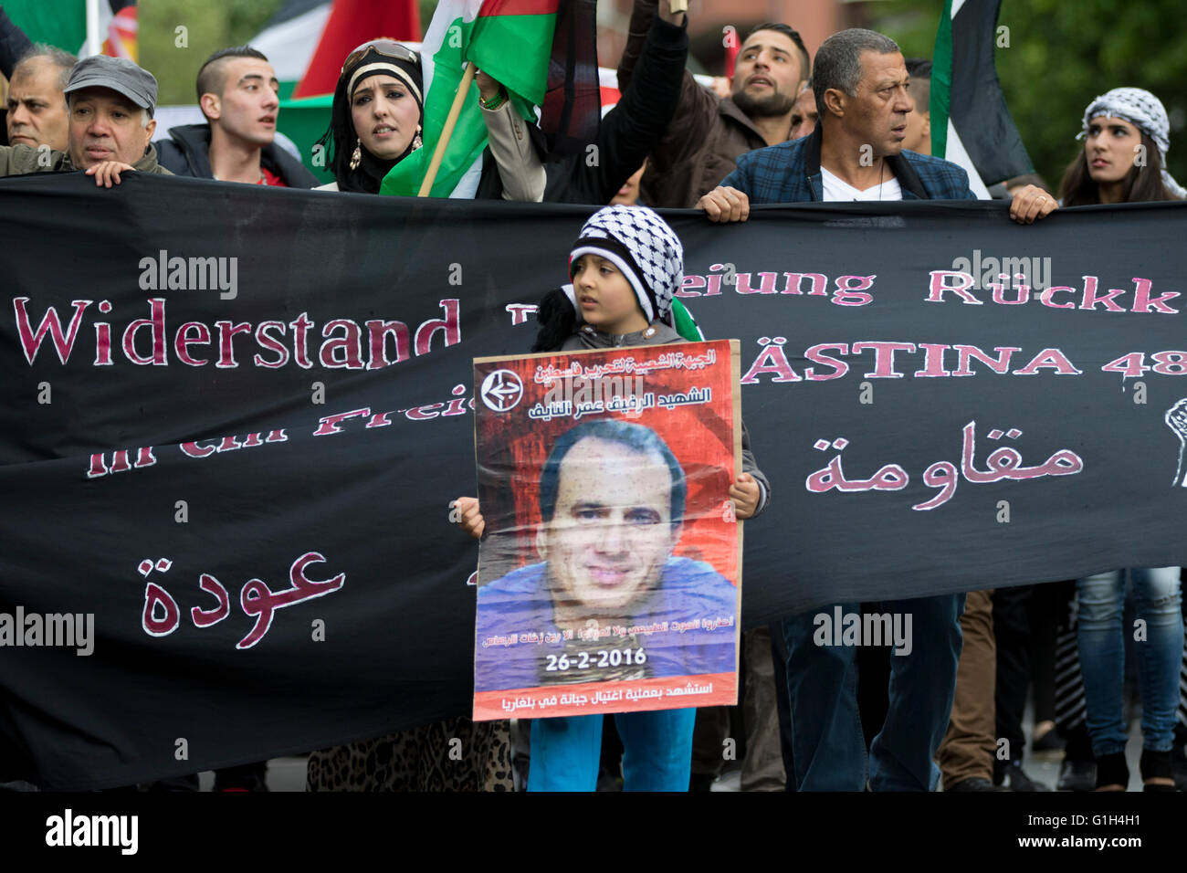 A young boy holds a poster on Nakba Day (Day of the Catastrophe) in ...