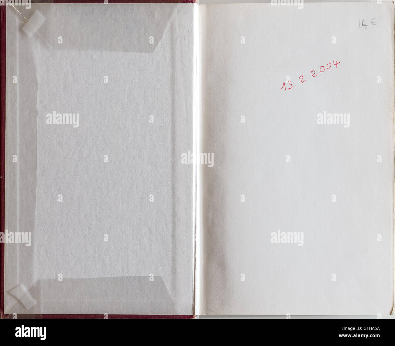 Old book opened to the first page showing blank pages with a date ...