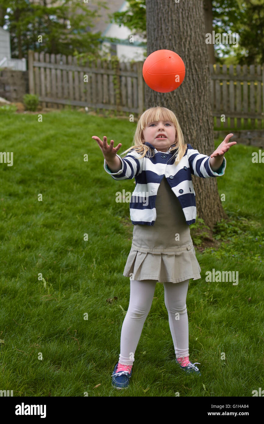 young girl playing catch with ball Stock Photo - Alamy
