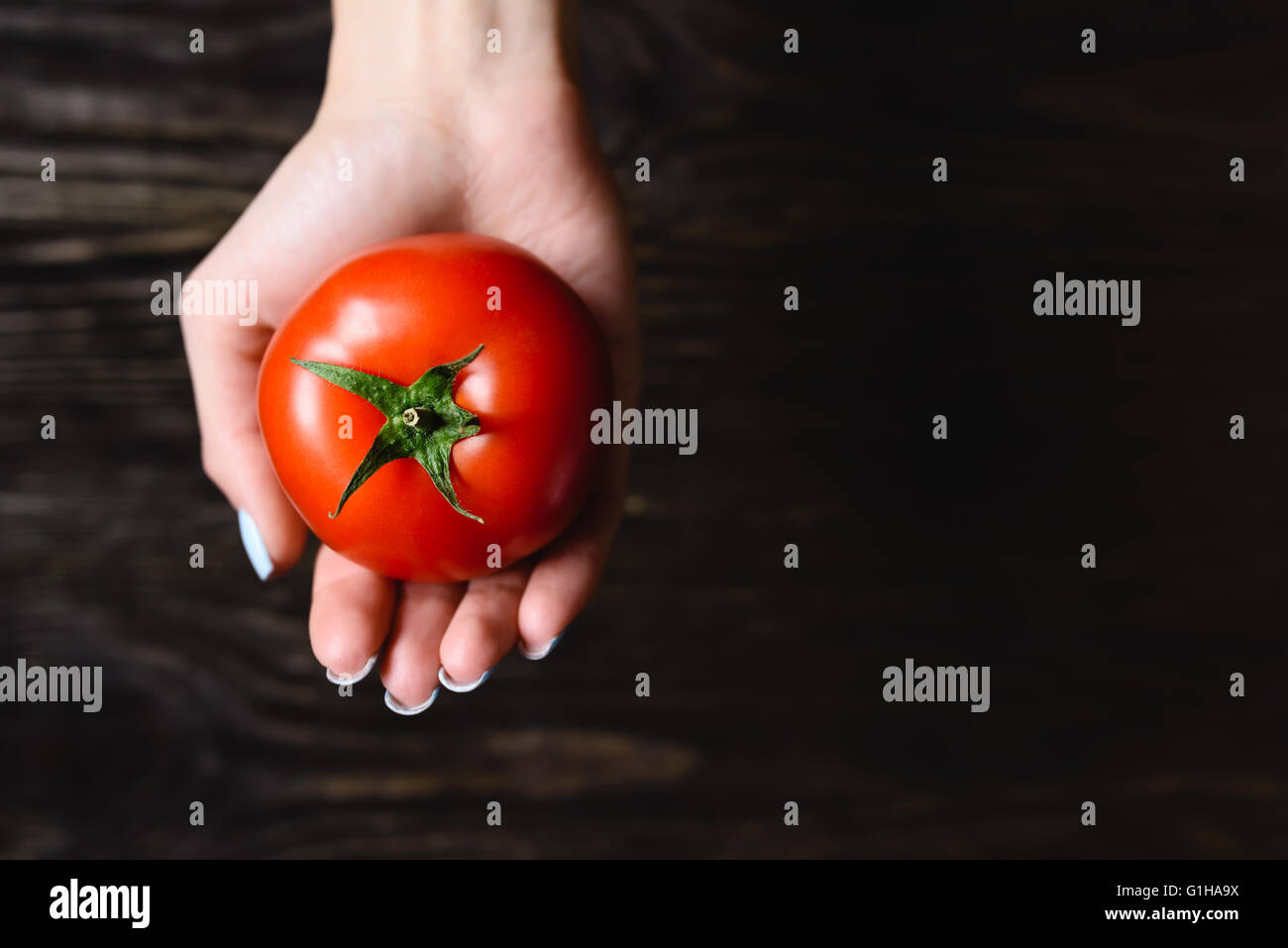 tomato in hand Stock Photo - Alamy