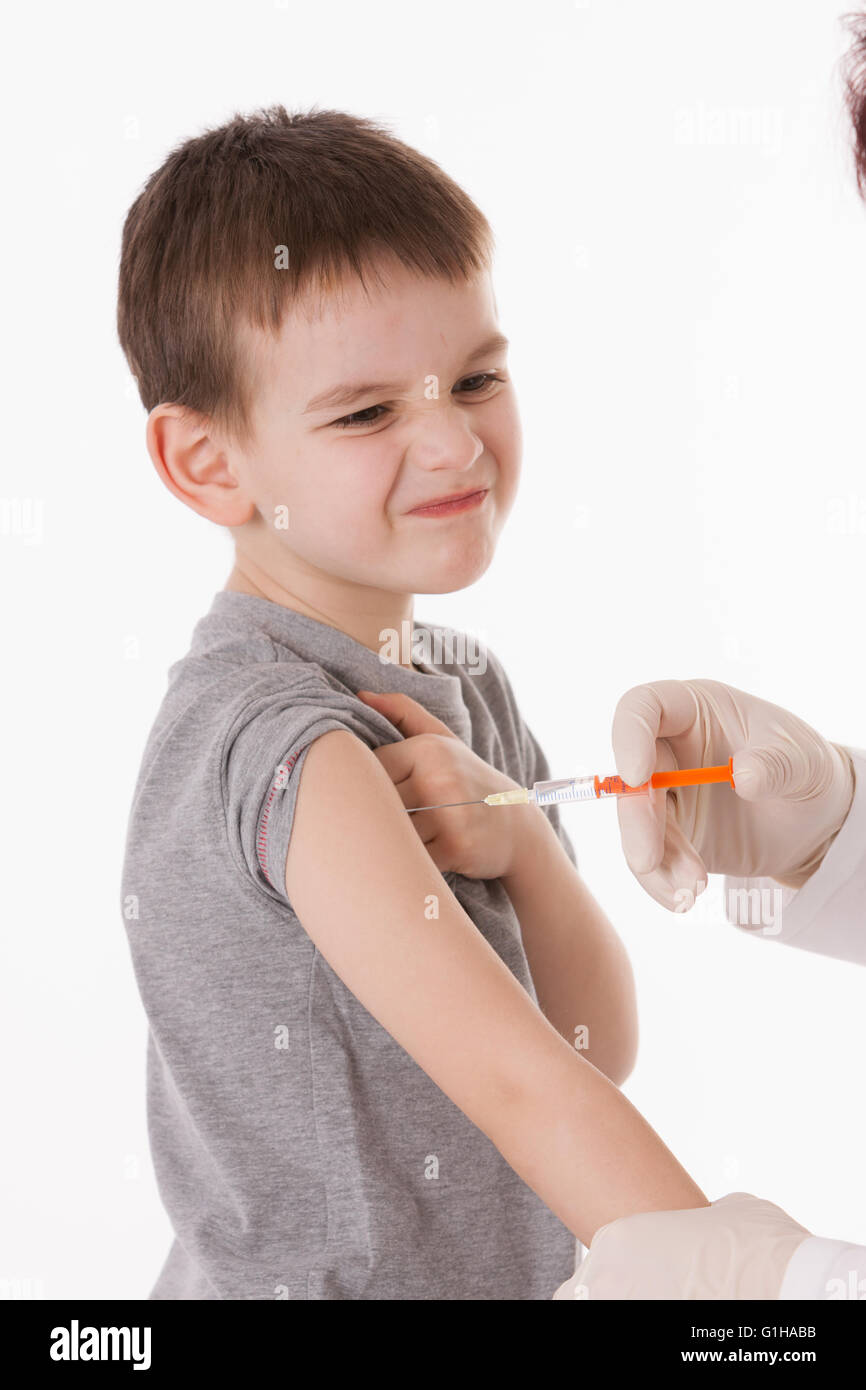 Doctor giving a child injection in arm on isolated image Stock Photo ...