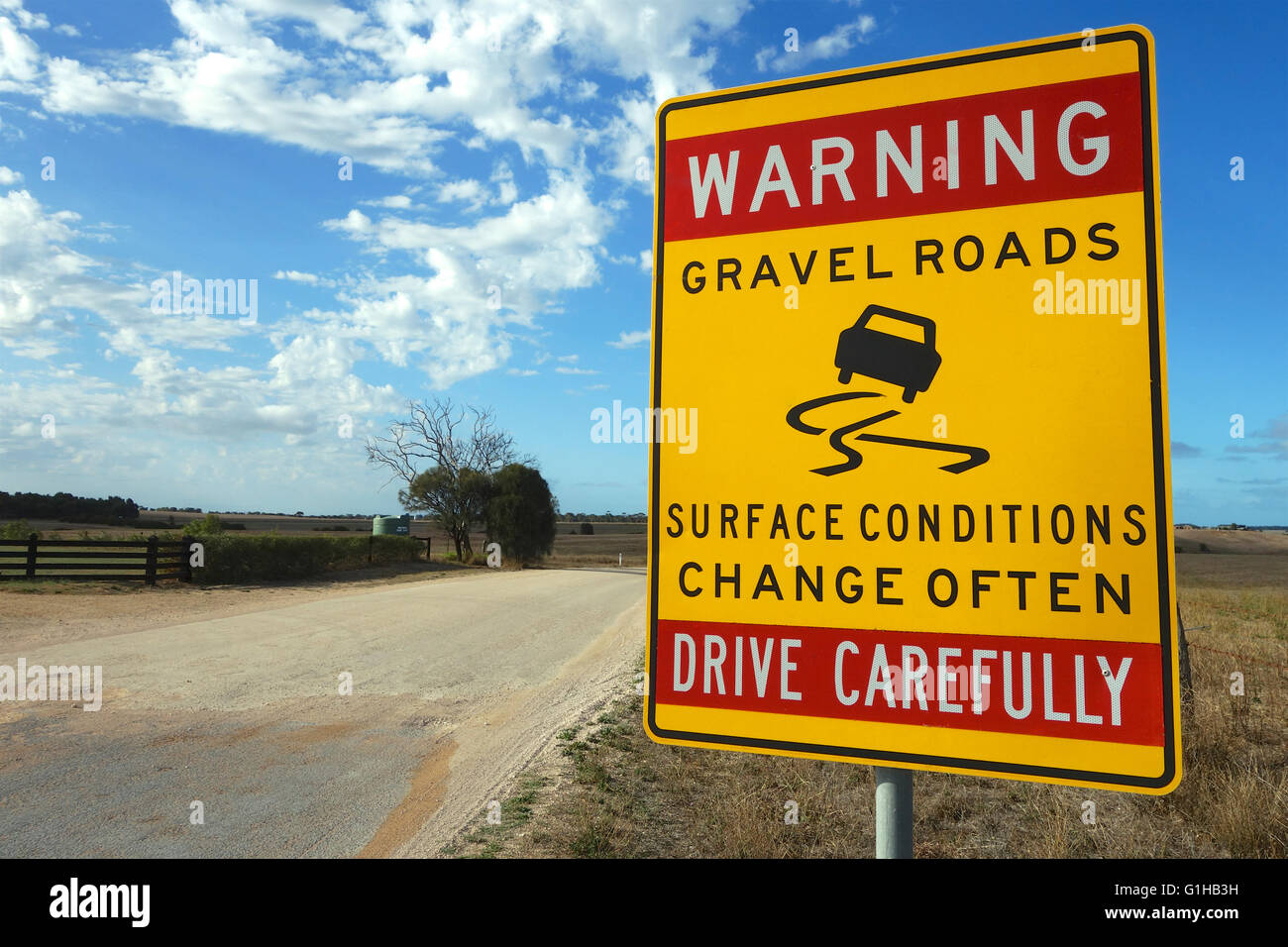 Warning: Gravel road sign Stock Photo - Alamy