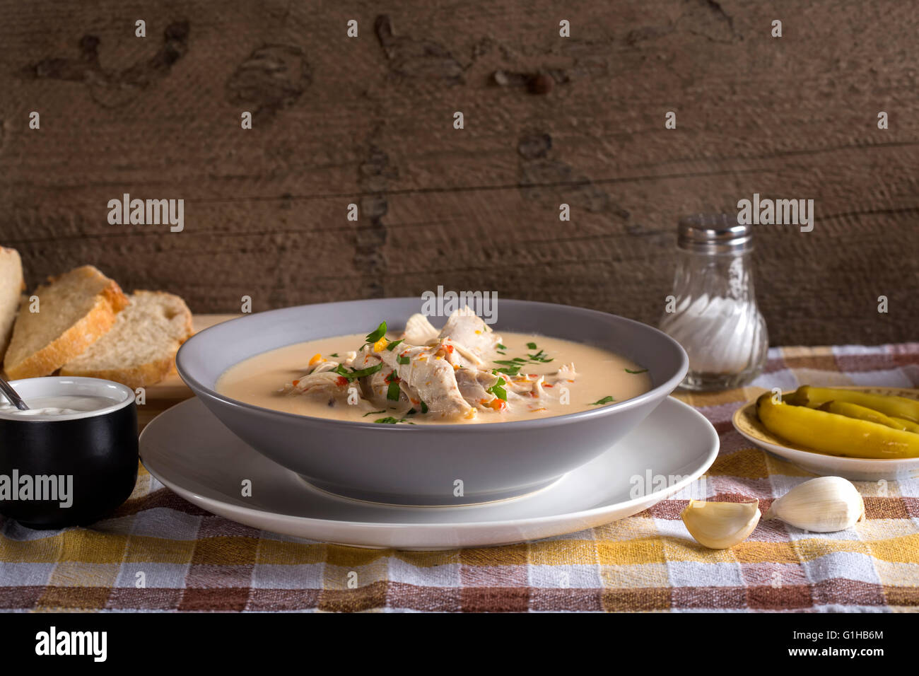 Romanian chicken soup named Ciorba Radauteana on plate Stock Photo - Alamy