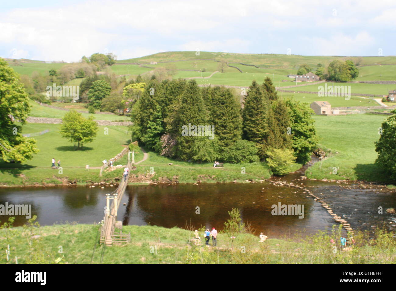 The suspension bridge crossing the River Wharfe at Hebden Stock Photo ...