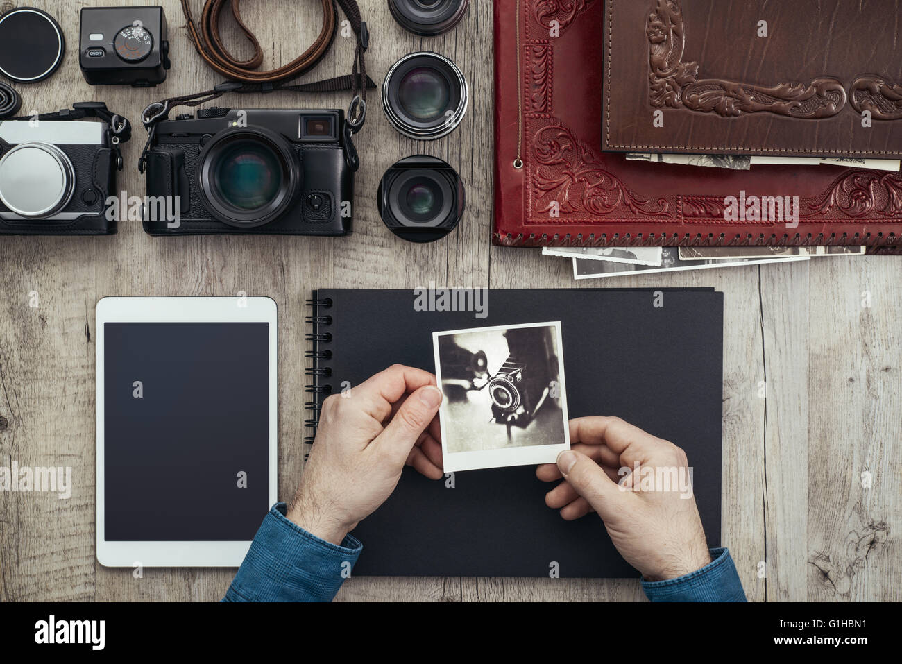 Photographic equipment, digital cameras and tablet on a vintage desktop ...