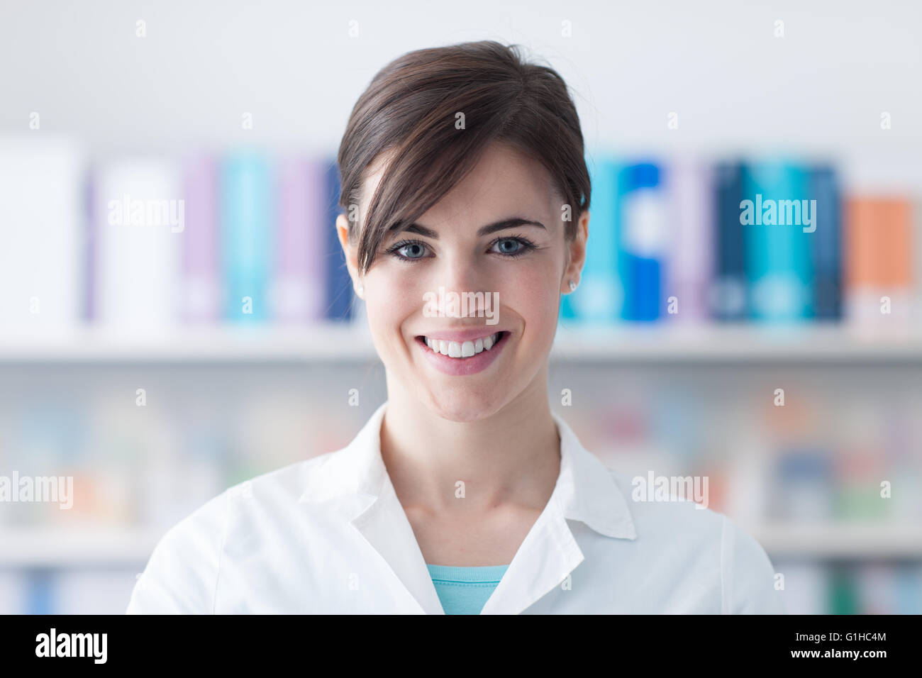 Smiling young doctor posing and looking at camera, healthcare ...