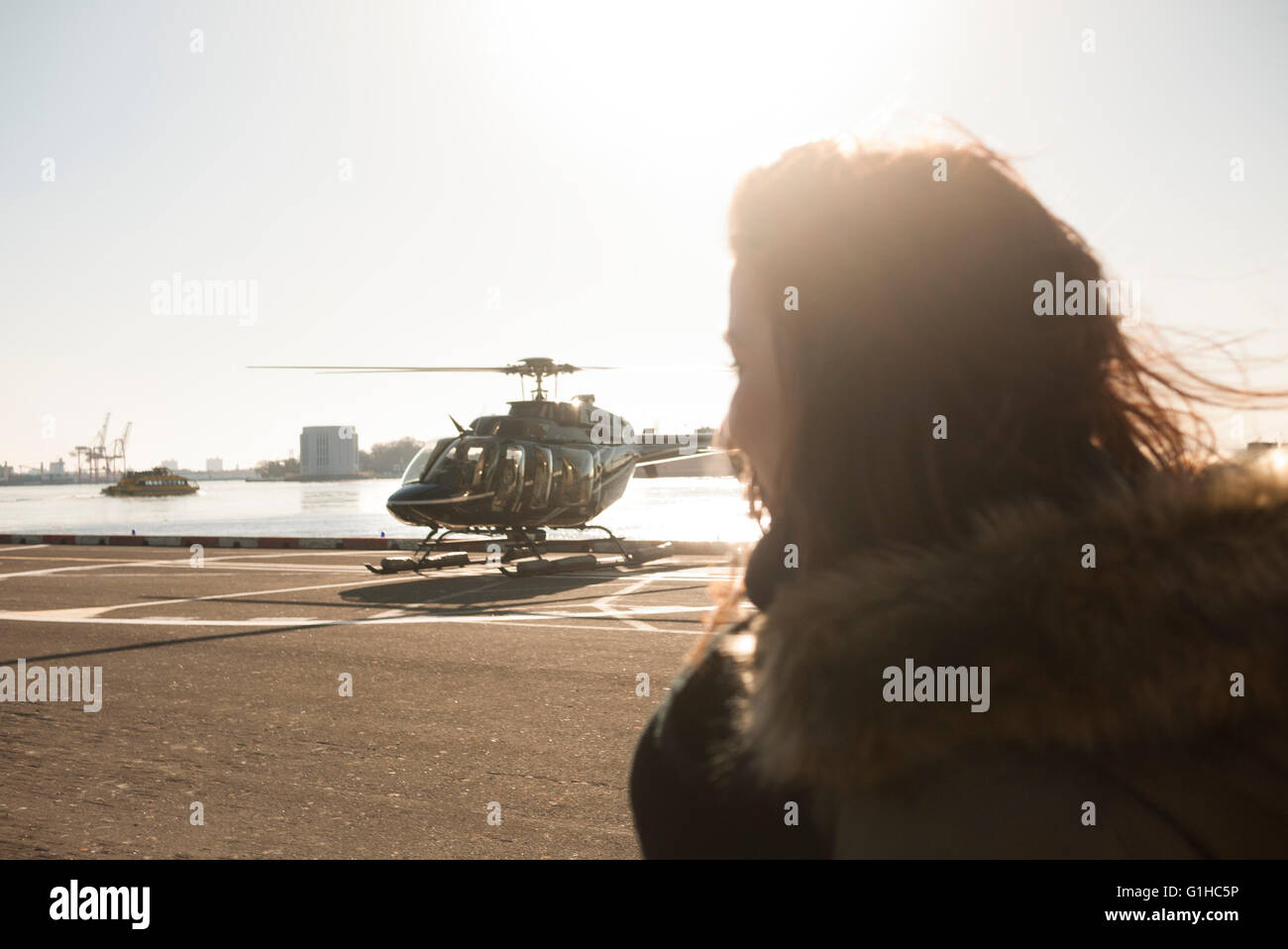 Portrait of beautiful women about to enjoy helicopter flight in New ...