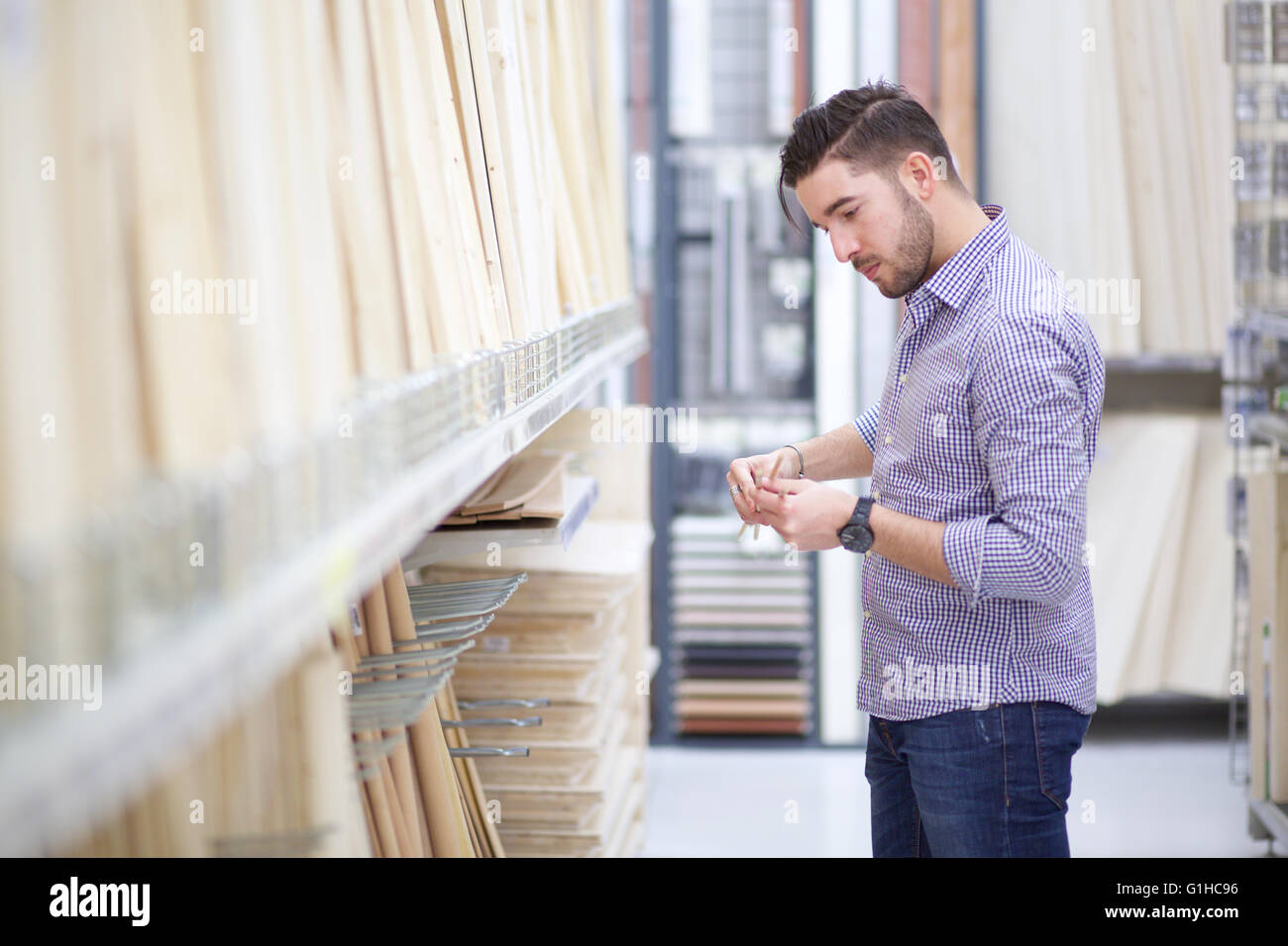 young man working in hardware store Stock Photo - Alamy