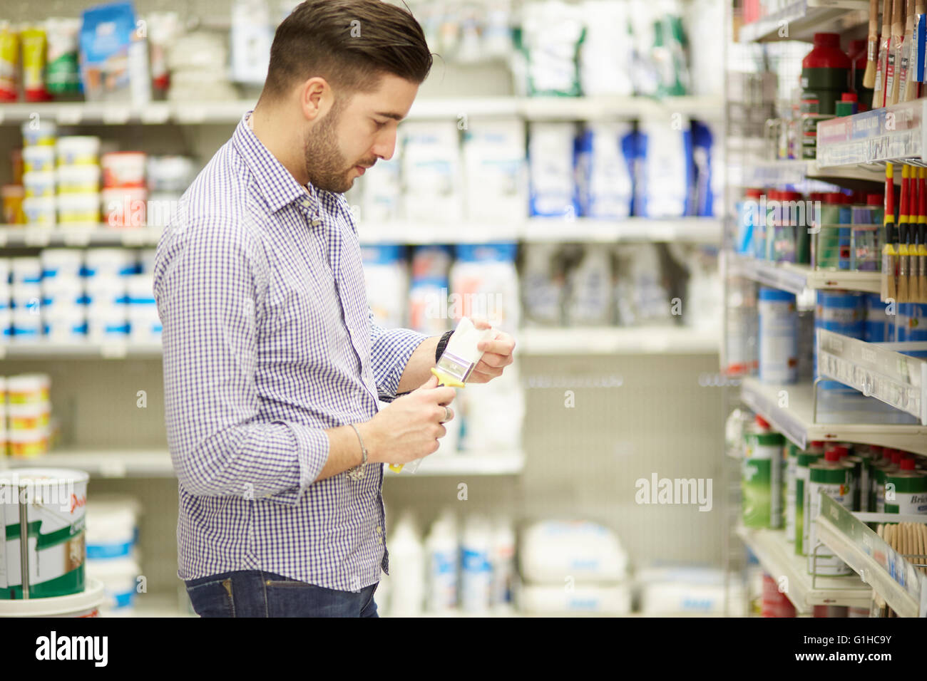 young man working in hardware store Stock Photo - Alamy