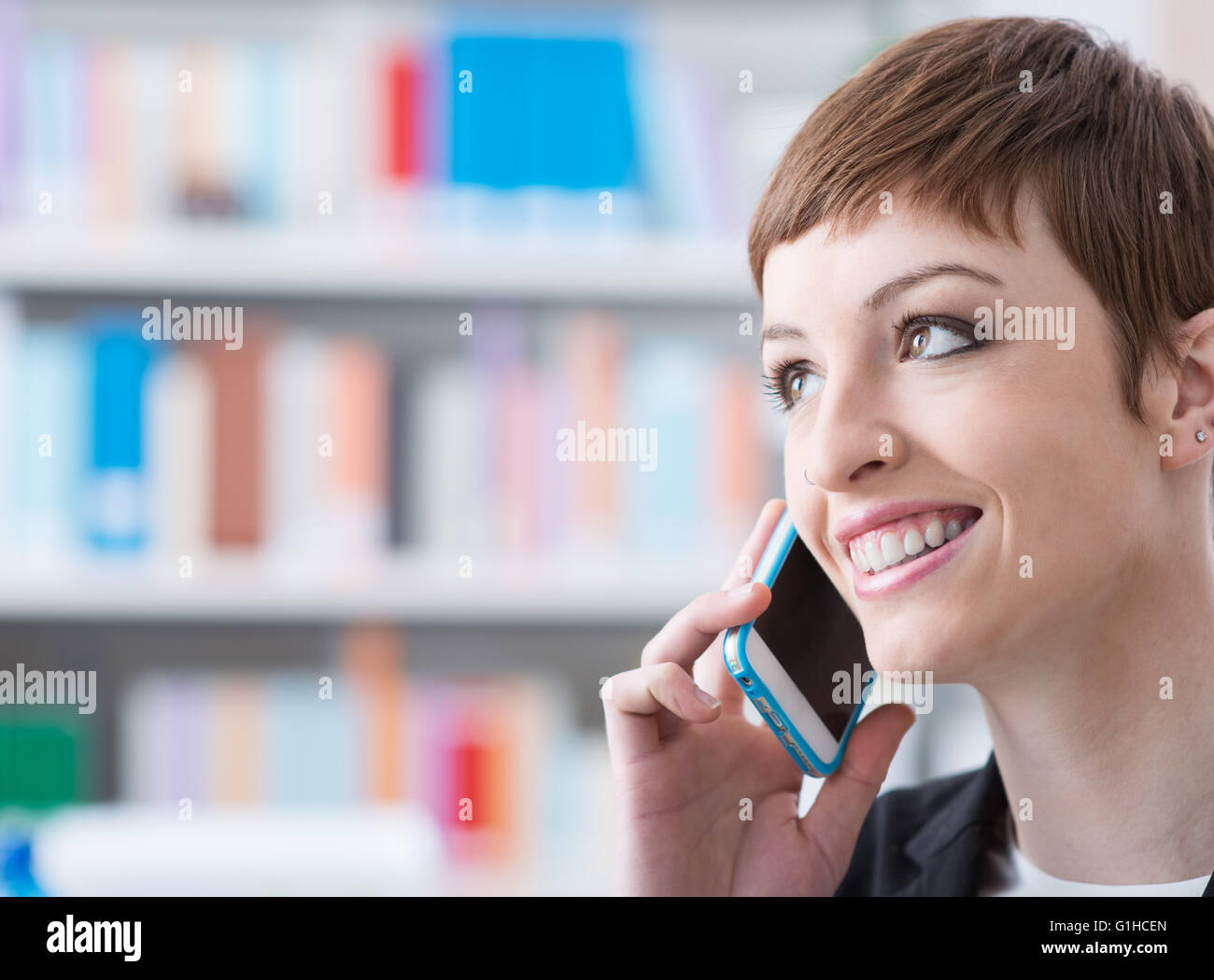 Smiling confident businesswoman on the phone, she is calling with a ...
