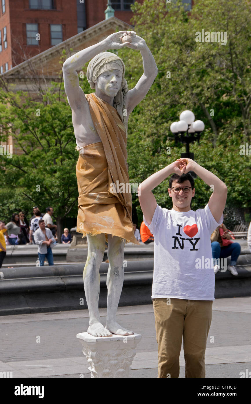 A busker who does mime and stands very still gets photobombed by a man ...