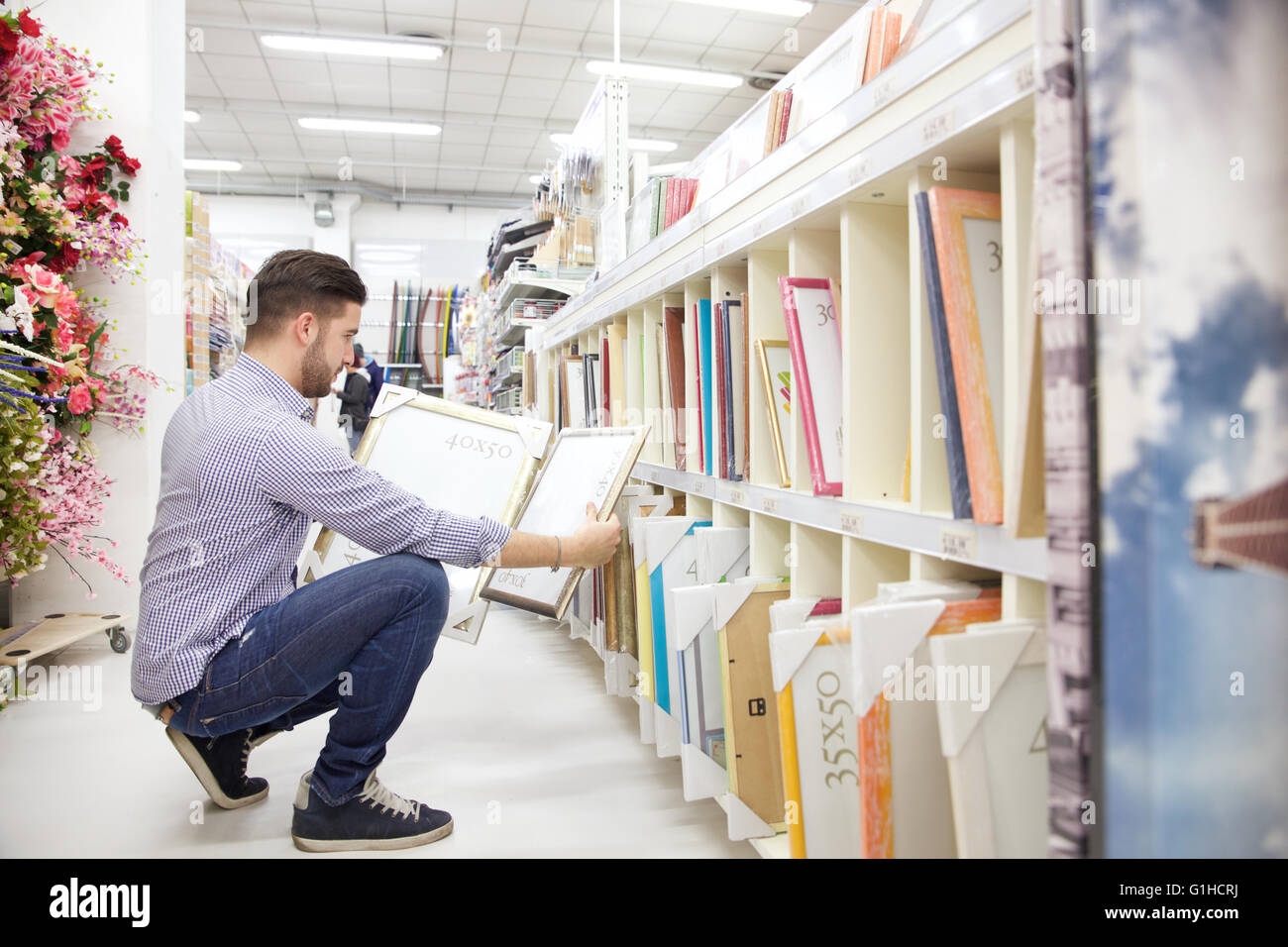 young man working in hardware store Stock Photo - Alamy