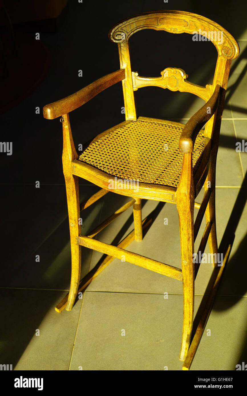Vintage style wooden baby chair in evening sun lights Stock Photo - Alamy